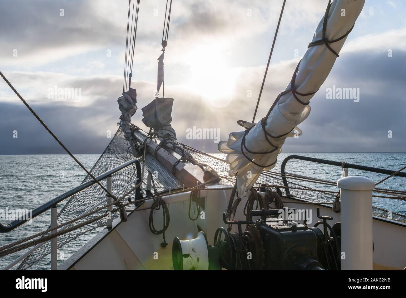 view on the ocean with mast of foredeck of a sailing ship Stock Photo ...