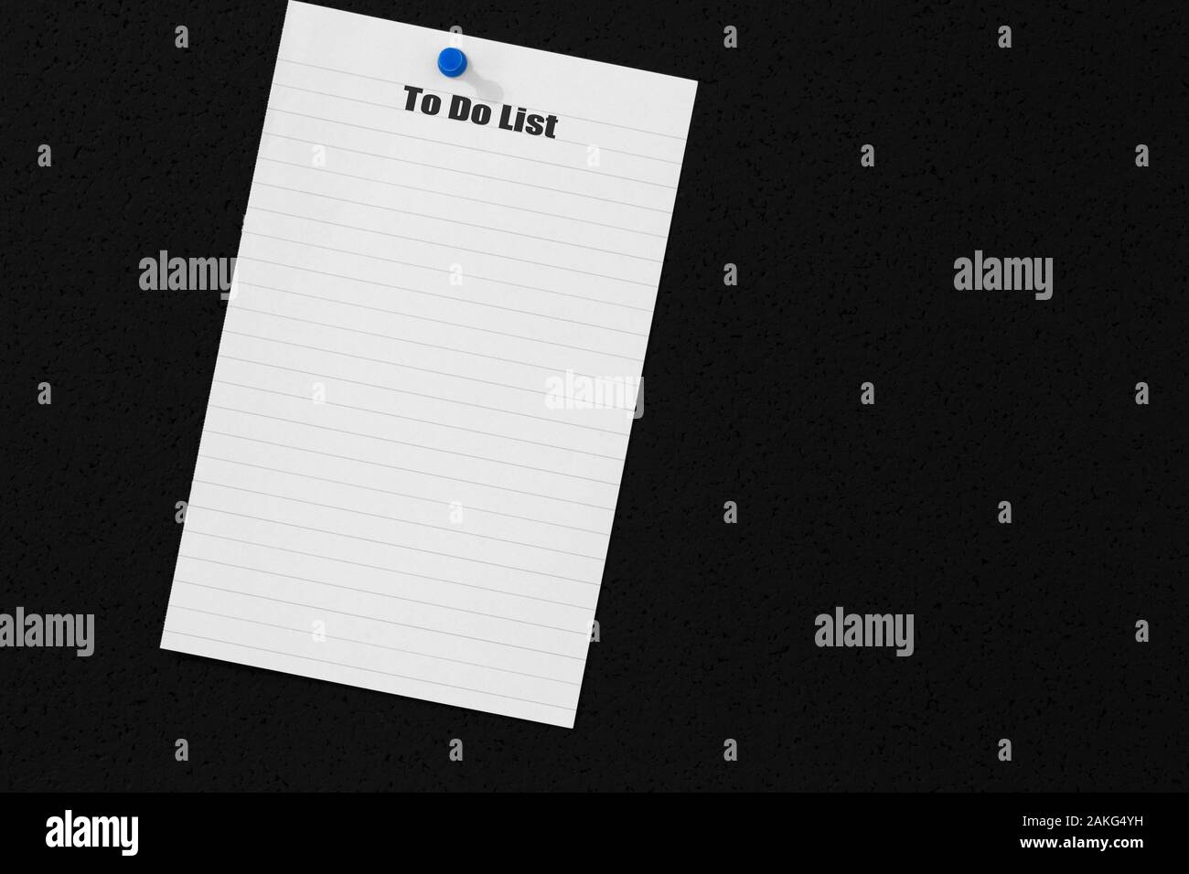 To do list on a page from a notebook stuck onto a black cork background ...