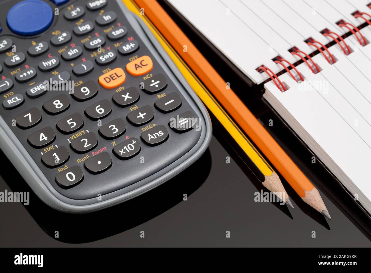 Close up Image of a Notebook, Two Pencils and a Calculator on a Desktop ...