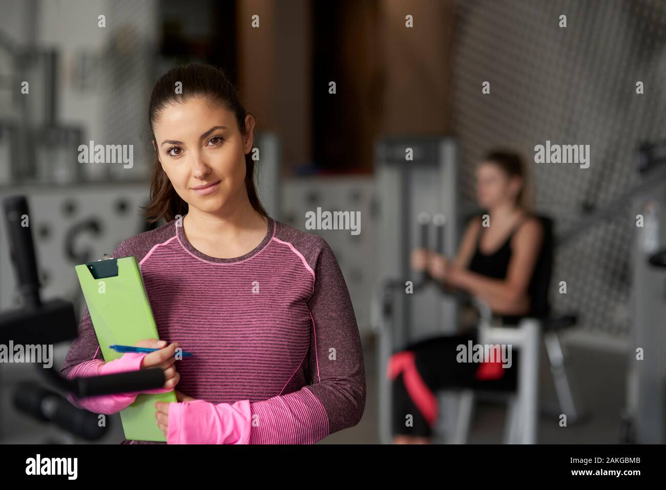 Portrait of personal trainer at the gym Stock Photo - Alamy