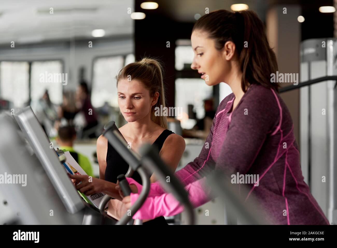 Female coach training young woman Stock Photo - Alamy