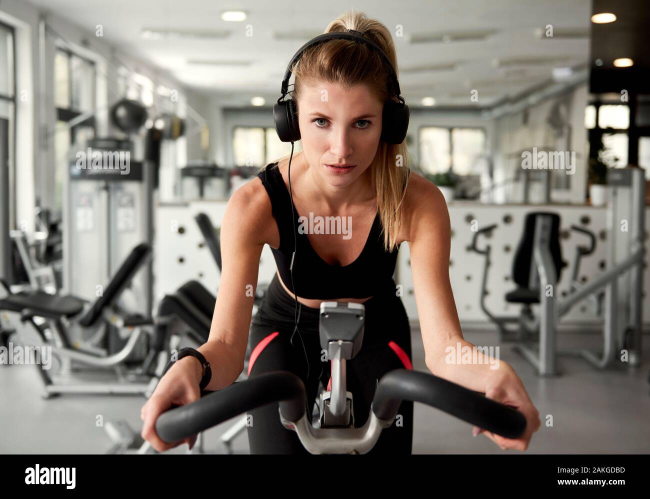 Sporty woman working out with exercise bike Stock Photo - Alamy