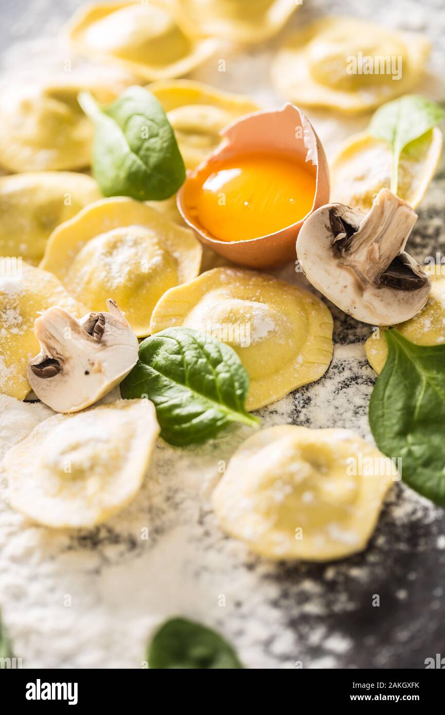 Raw ravioli with flour egg musrooms and and spinach - Top of view ...