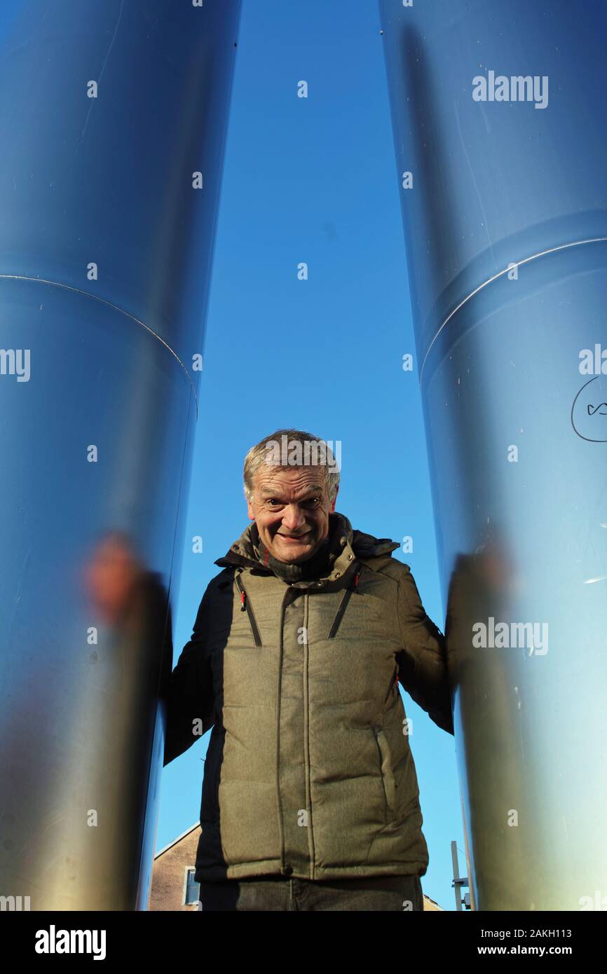 man between metal columns, poles Stock Photo - Alamy