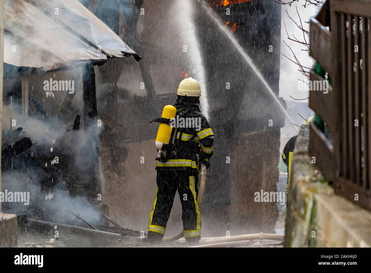 firemen fighting a fire in wood house Stock Photo - Alamy