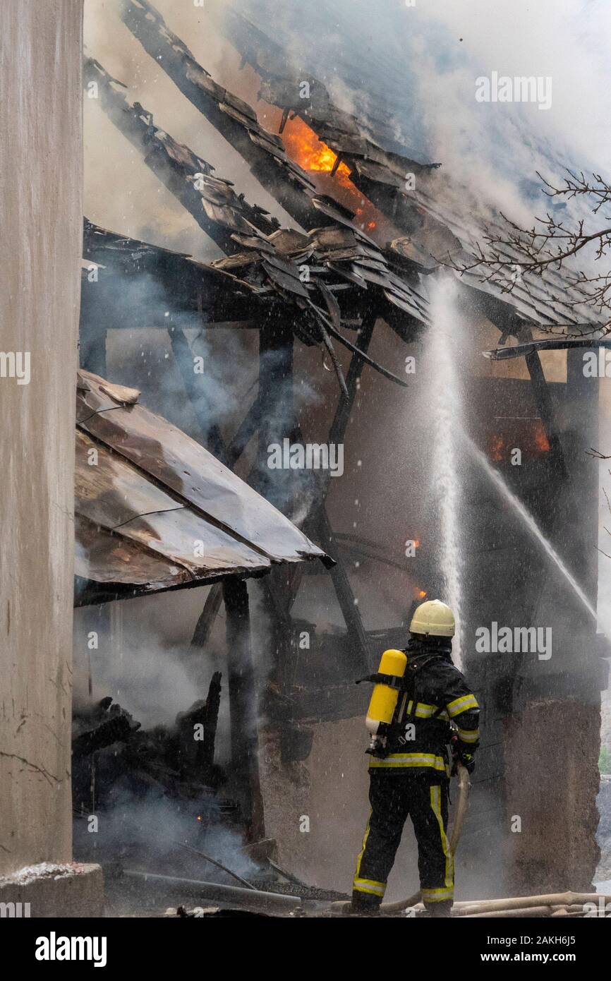 firemen fighting a fire in wood house Stock Photo - Alamy