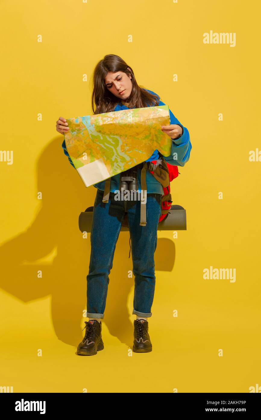 Smiling, looking for way. Portrait of a cheerful young caucasian ...