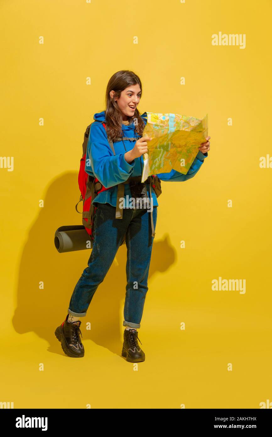 Smiling, looking for way. Portrait of a cheerful young caucasian ...