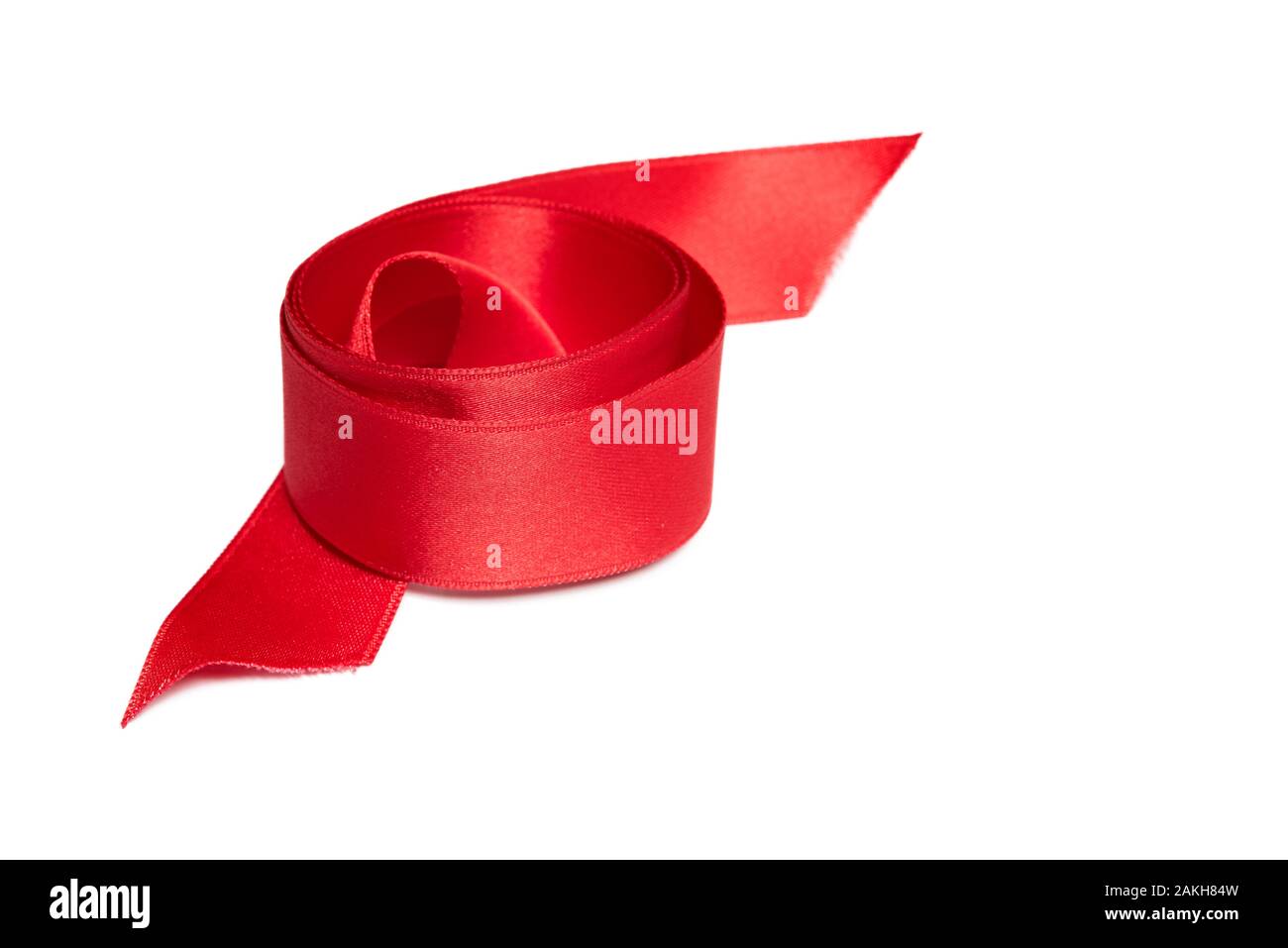 red ribbon roll on a white background Stock Photo - Alamy