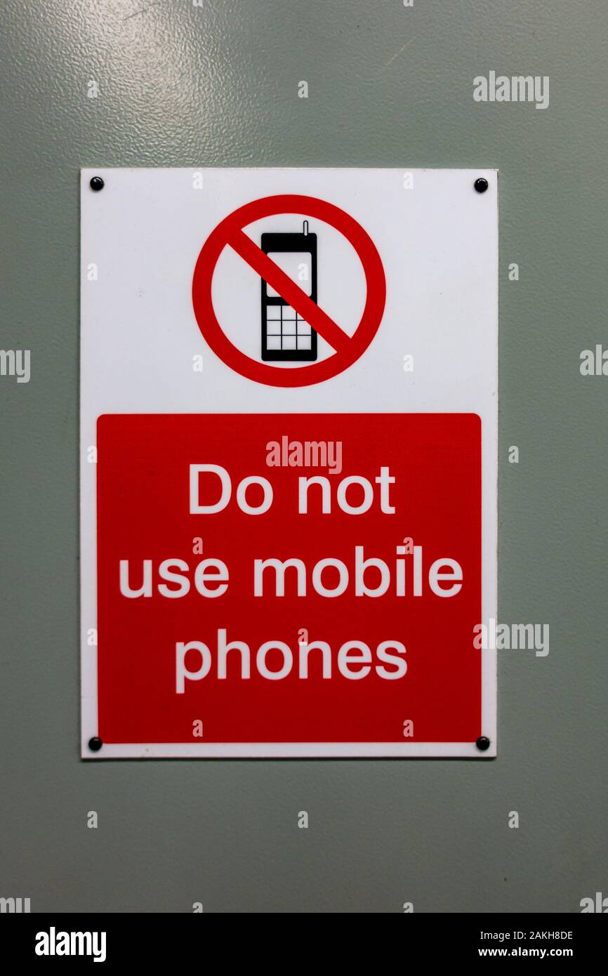 Do not use mobile phones warning sign on an electrical equipment ...