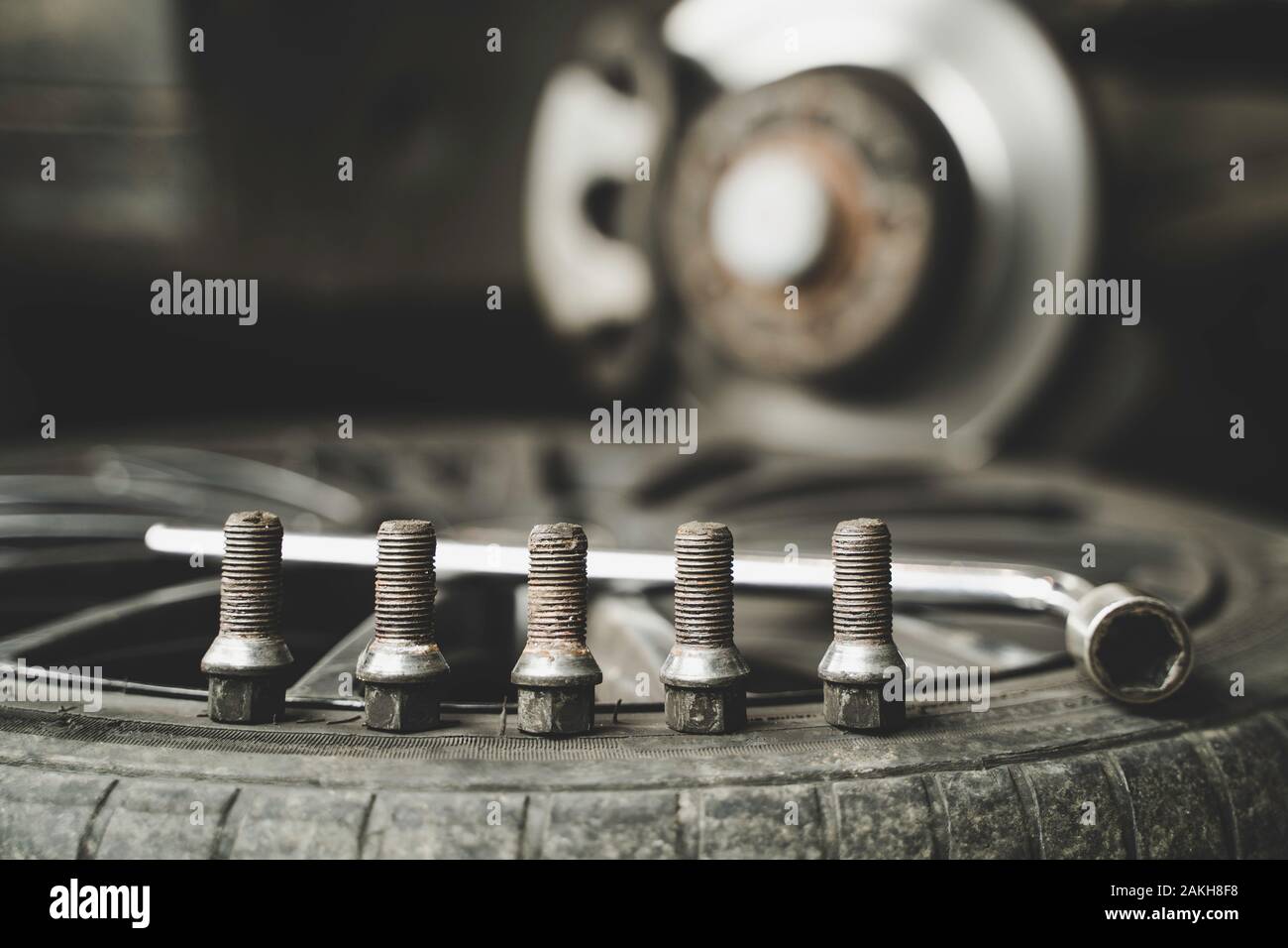 Wheel bolts on a wheel in straight line. Break disck of a car and a ...