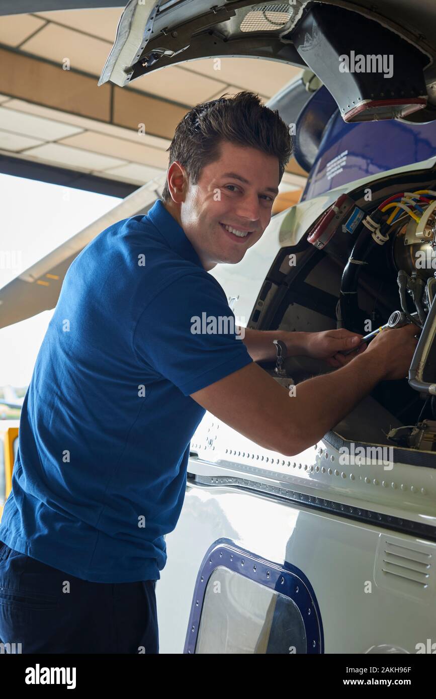 Portrait Of Male Aero Engineer Working On Helicopter In Hangar Stock ...
