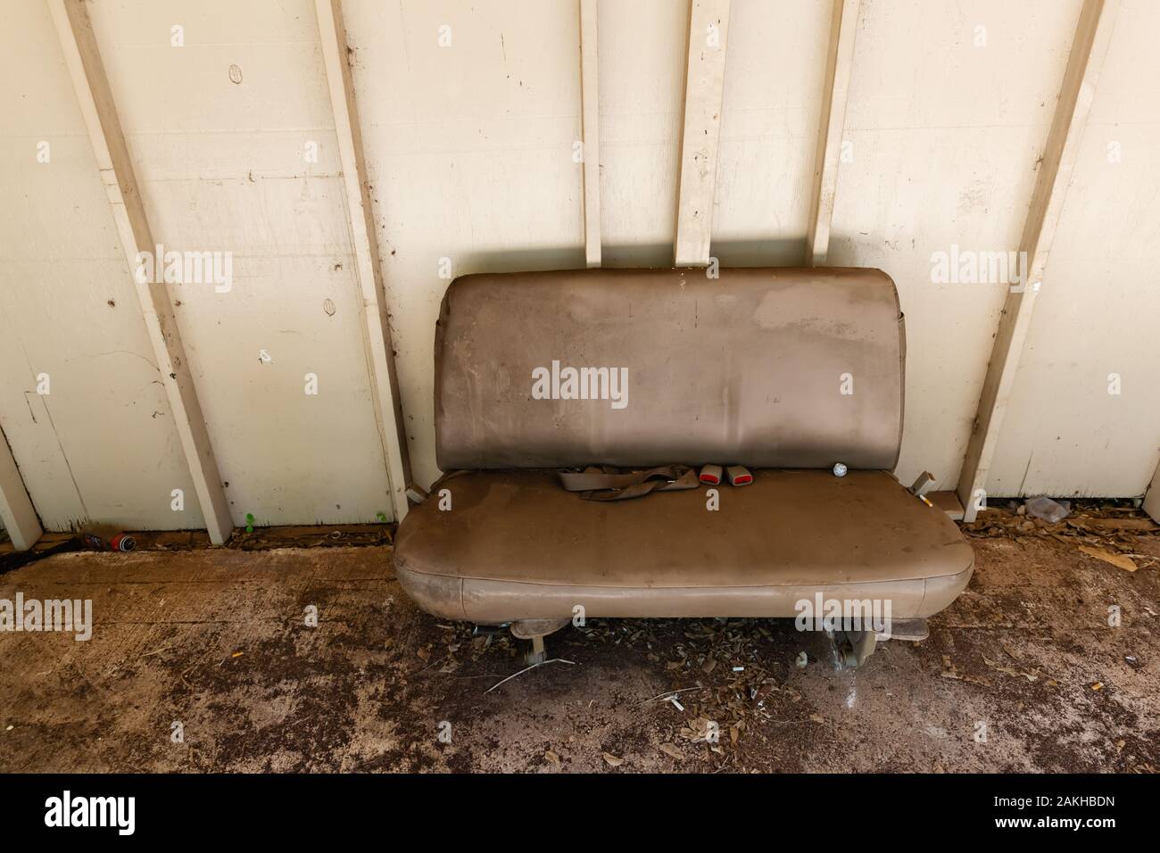 picture of a run down and decommissioned car seat in front of a ...
