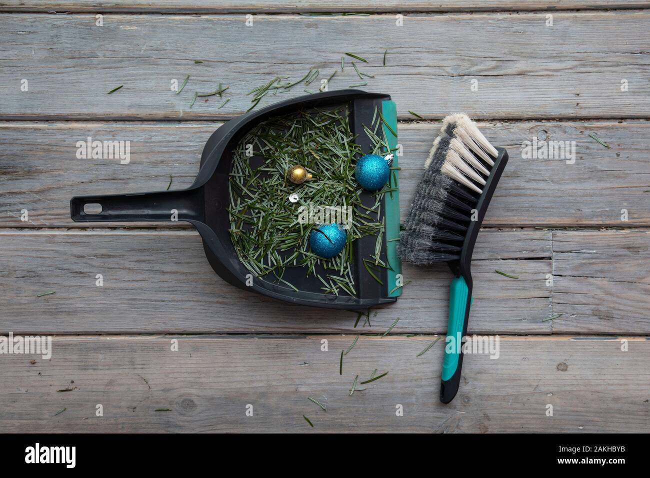 Cleaning up after christmas. Sweeping up pine needles and broken ...