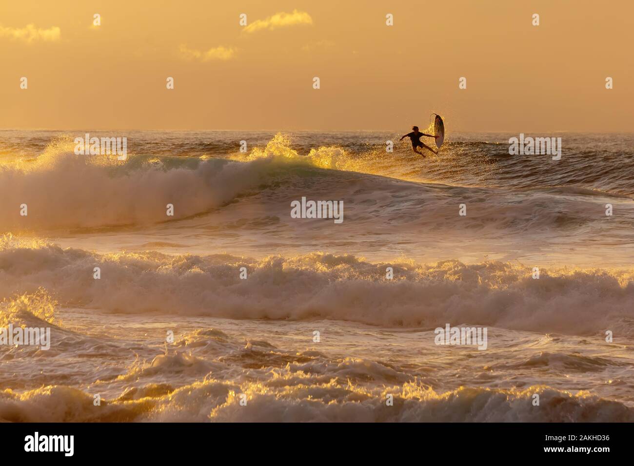 waves at the North Shore of Oahu, Hawaii, with an unrecognizable surfer ...