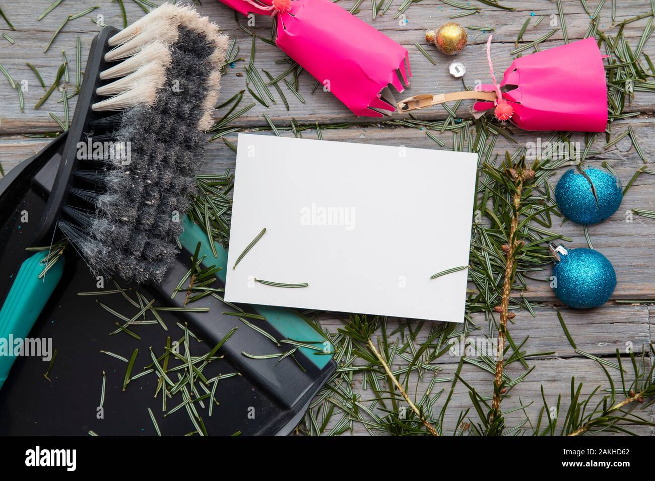 Cleaning up after christmas. Sweeping up pine needles and broken ...