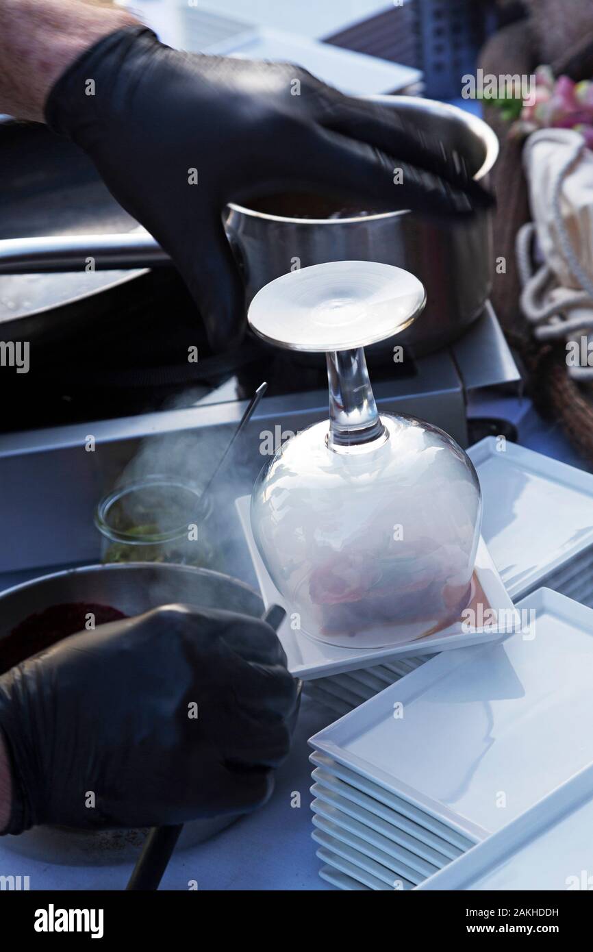 A chef adds the flavour of smoke to a dish served at Zell am See ...