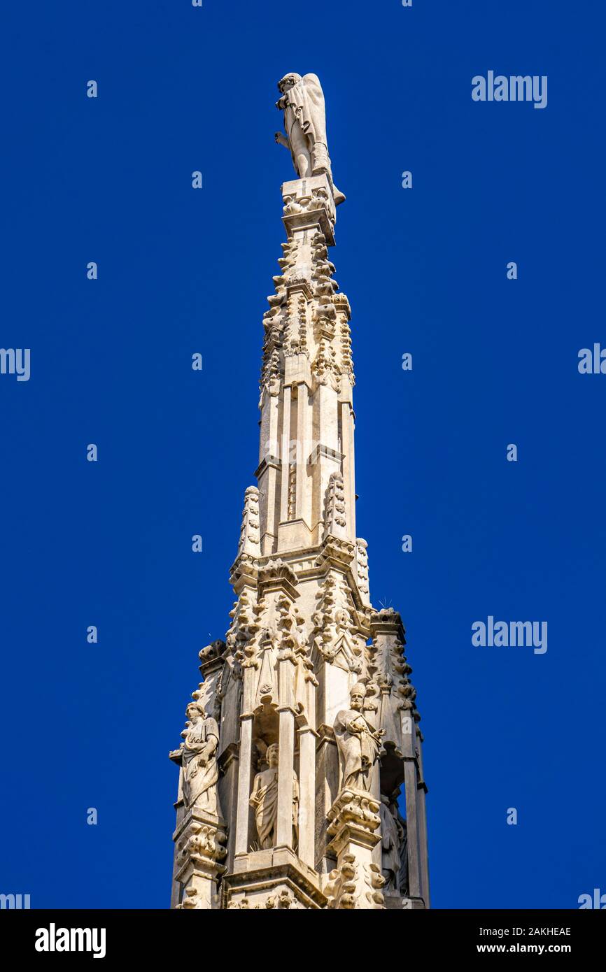 View at white marble spires on the roof of famous Cathedral Duomo di ...