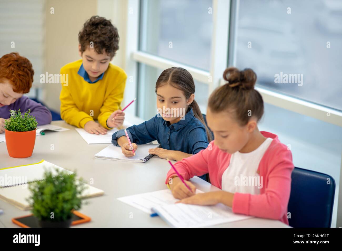 Pupils working on test assignment during the lesson Stock Photo - Alamy