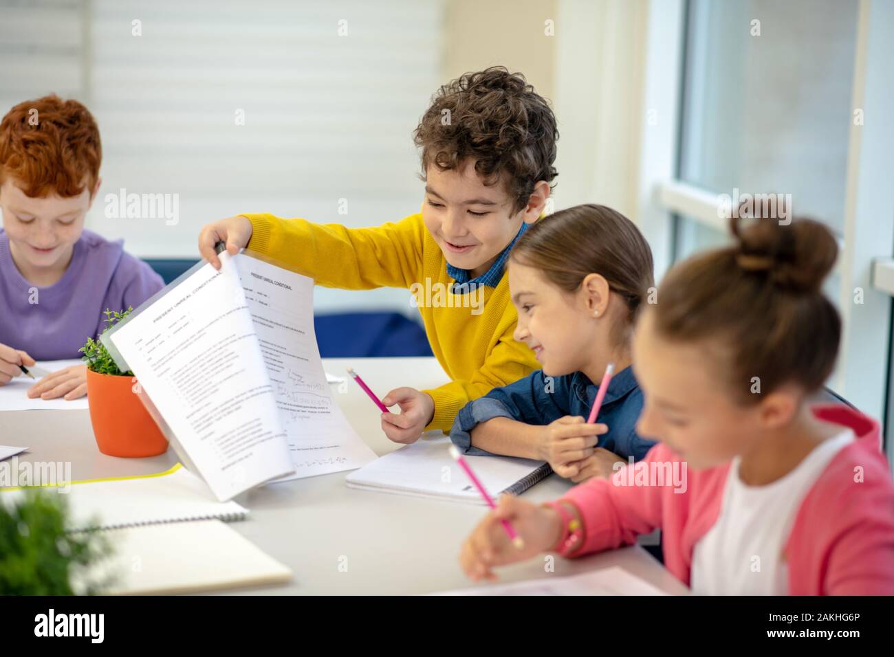 Generous boy sharing his test answers with the classmate Stock Photo ...