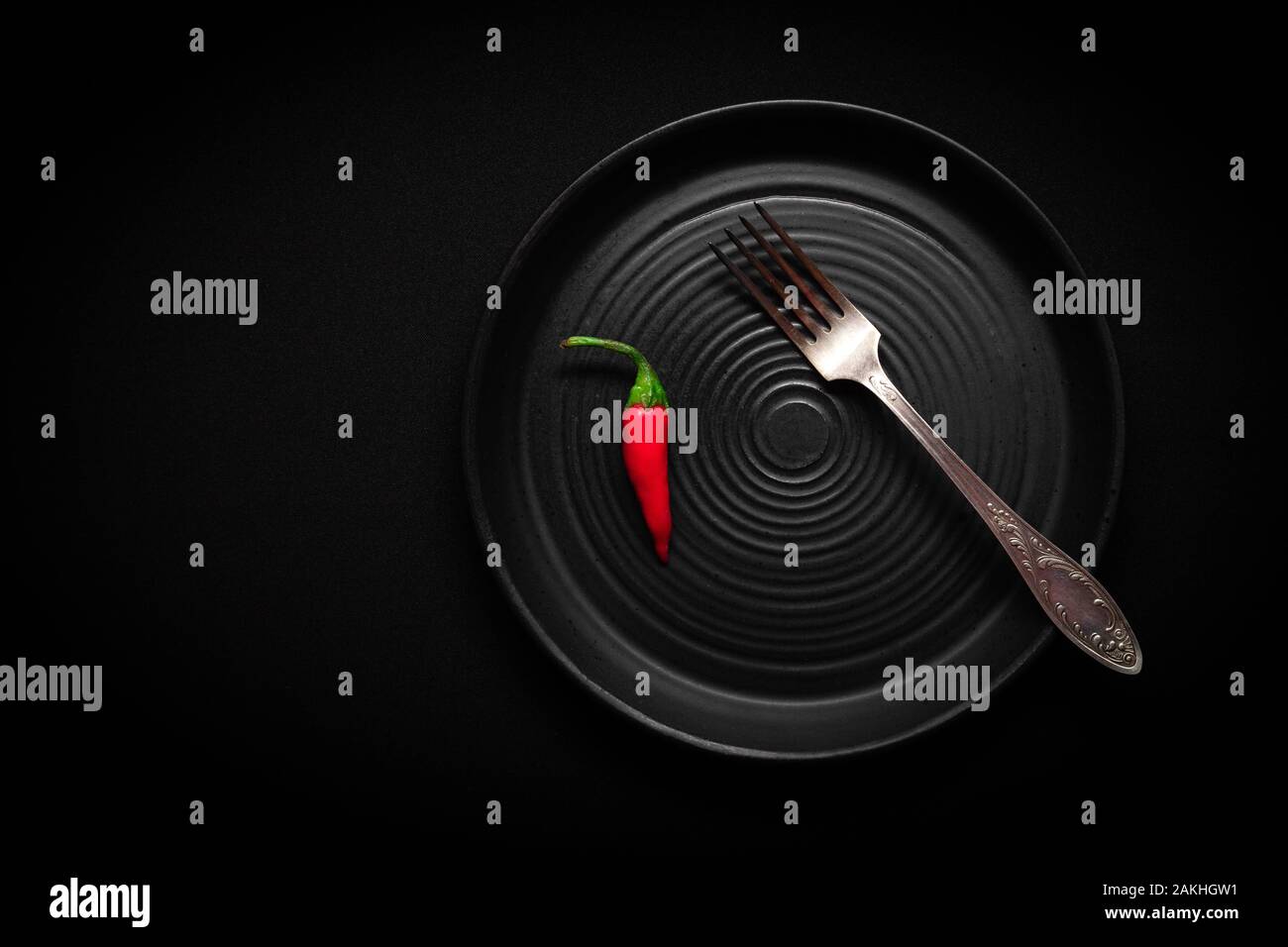 Closeup round ceramic plate with pattern of circles, vintage fork, red ...