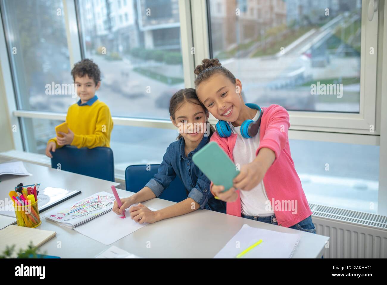 Two girls making selfie at school using a smartphone Stock Photo - Alamy