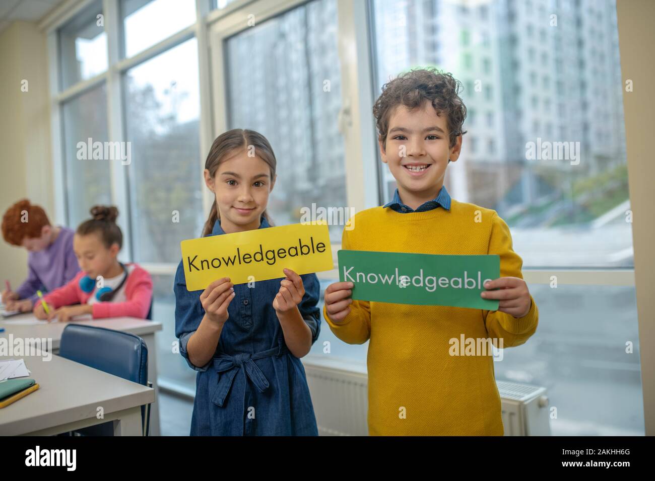 Children playing words game during the lesson Stock Photo - Alamy