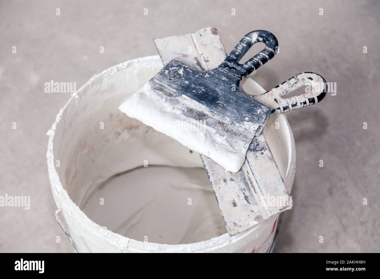 Decorative cement plaster and trowel in construction bucket ready for ...