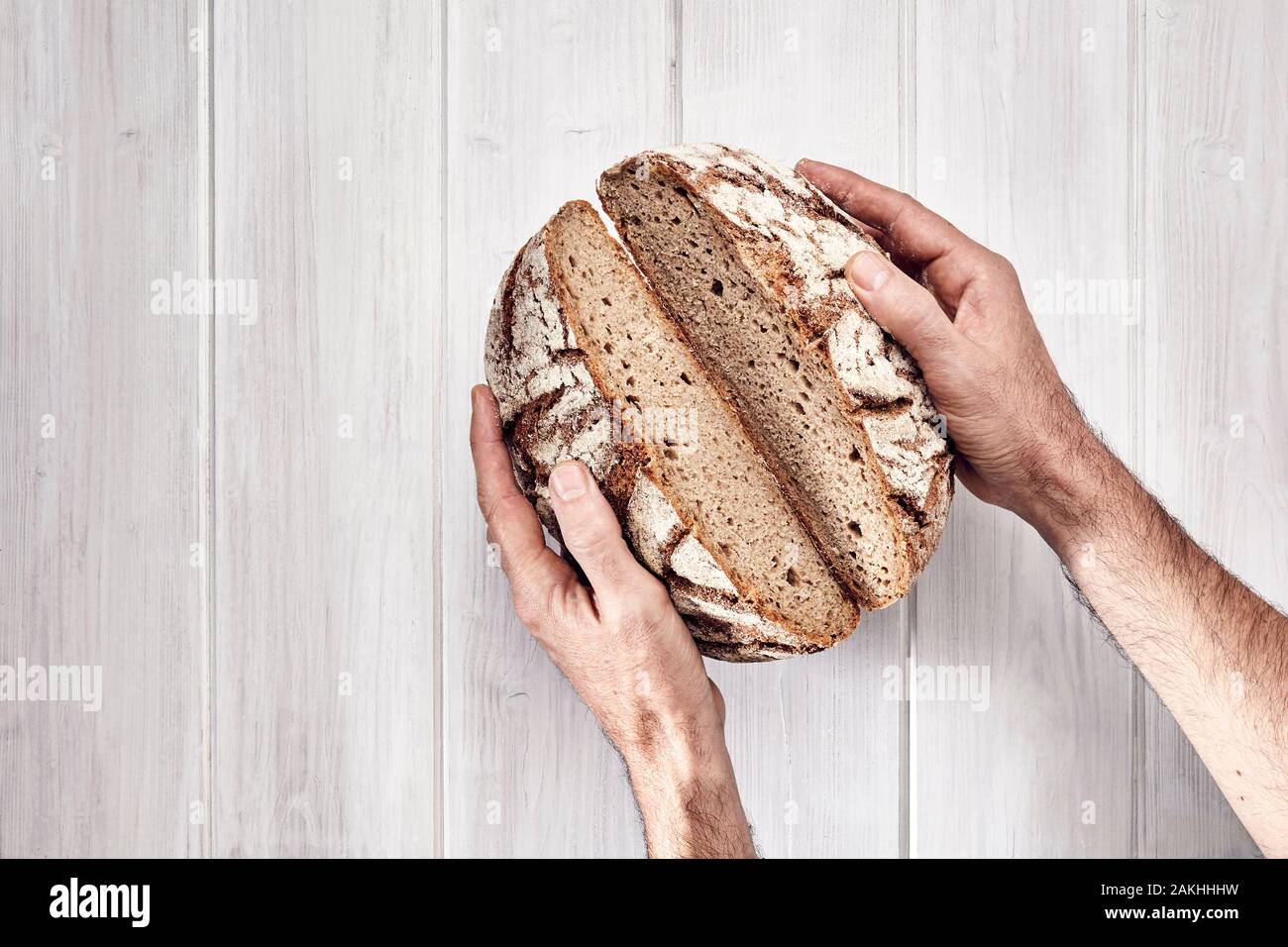 Holding a loaf of bread in his hands hi-res stock photography and ...