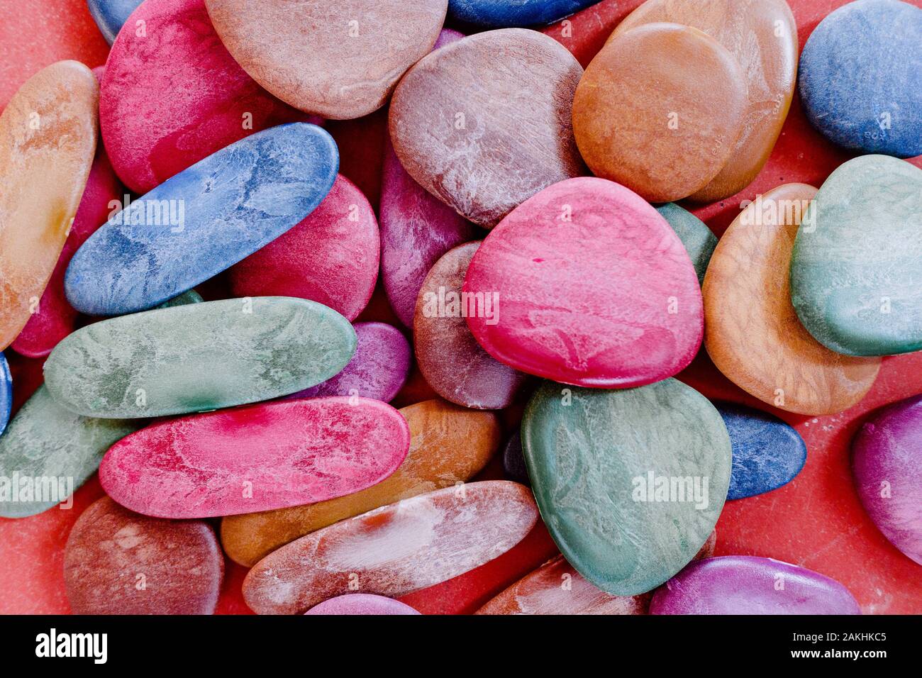 Colored plastic pebbles to play babies Stock Photo - Alamy
