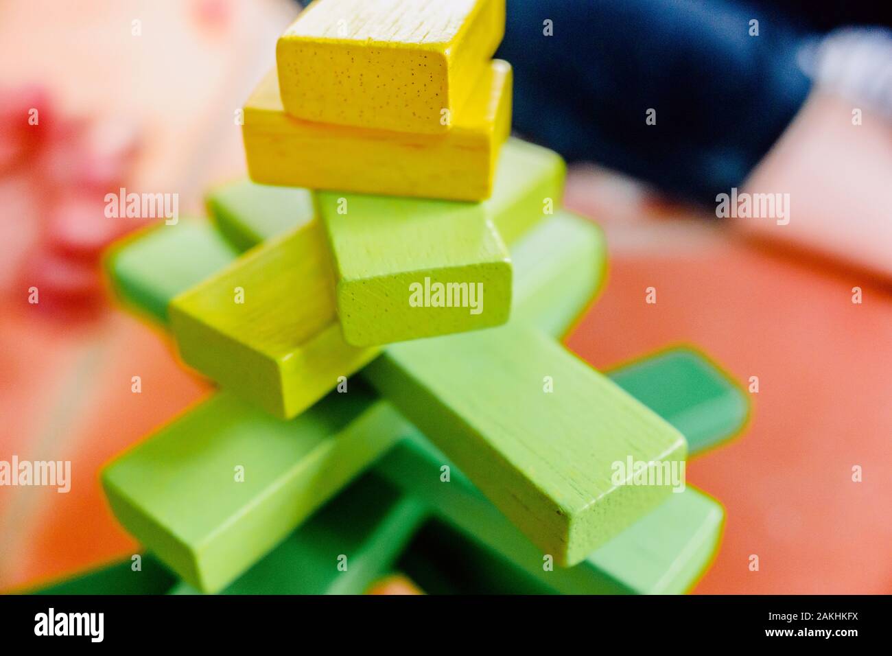 Yellow wooden blocks in balance in a toy tower Stock Photo - Alamy