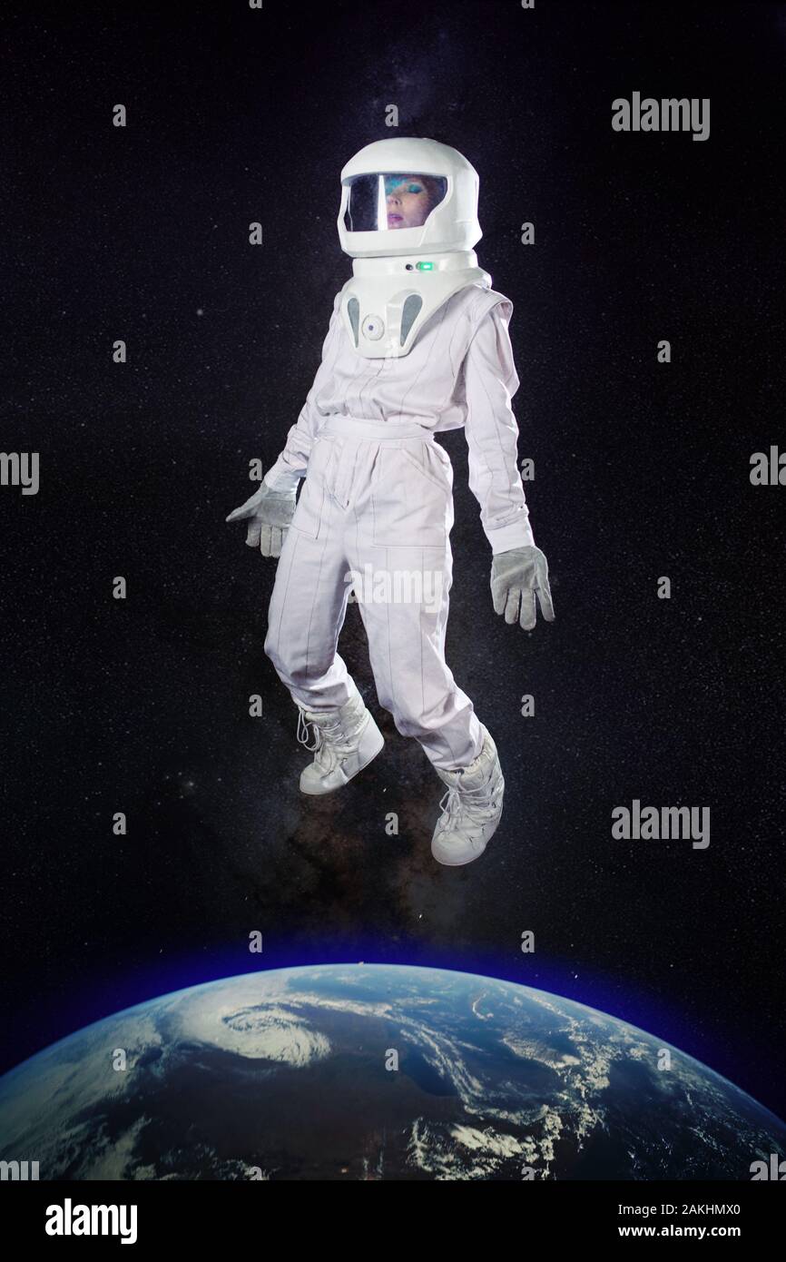 Astronaut in space, in zero gravity near planet Earth. Elements of this ...