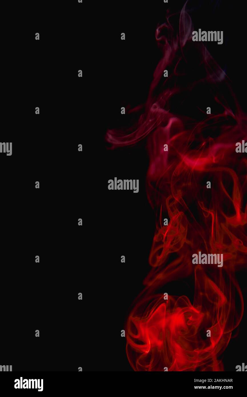 colorful smoke streaks on a dark background Stock Photo - Alamy