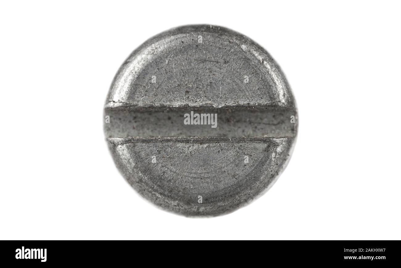 Dirty old metal screw or bolt head isolated on white background. Macro ...
