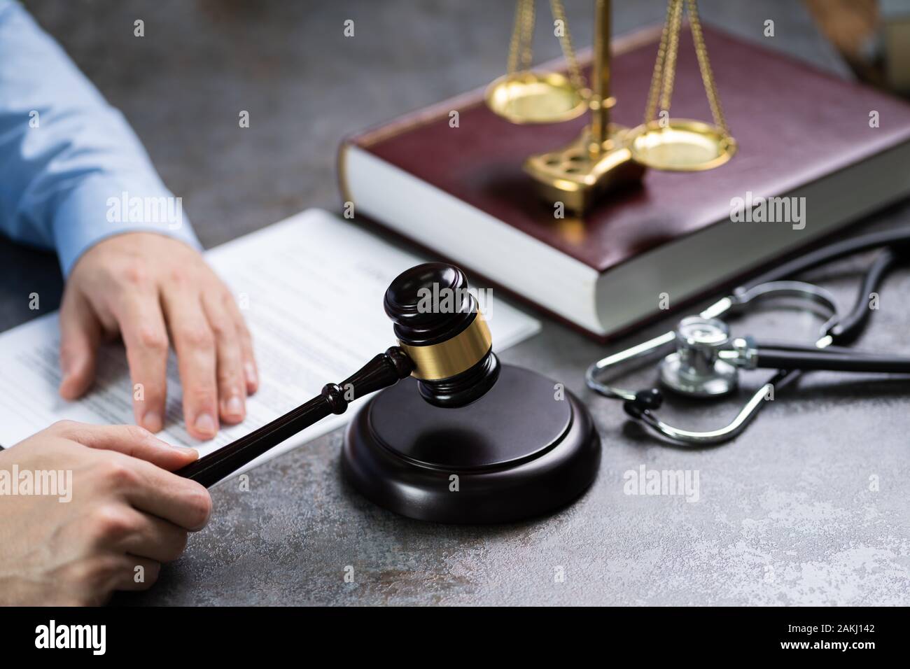 Judge Hitting Gavel With Stethoscope In Courtroom Stock Photo - Alamy