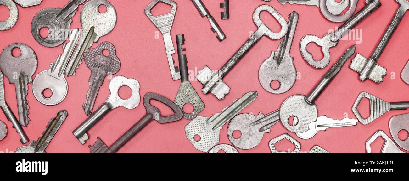 Keys set on pink background. Door lock keys and safes for property ...