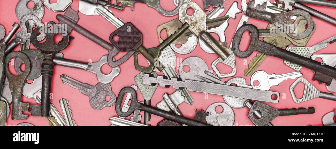 Keys set on pink background. Door lock keys and safes for property ...