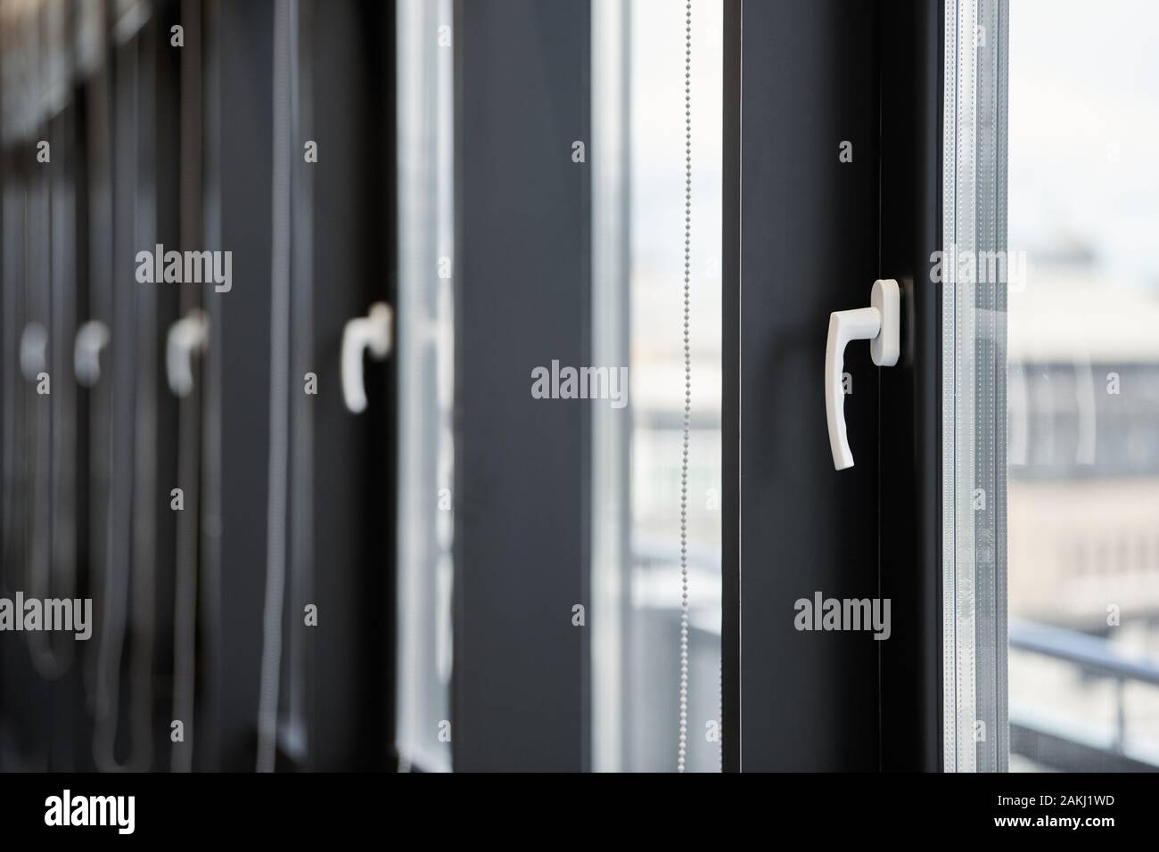 Windows row in office building. Modern windows with handles. Rows of ...