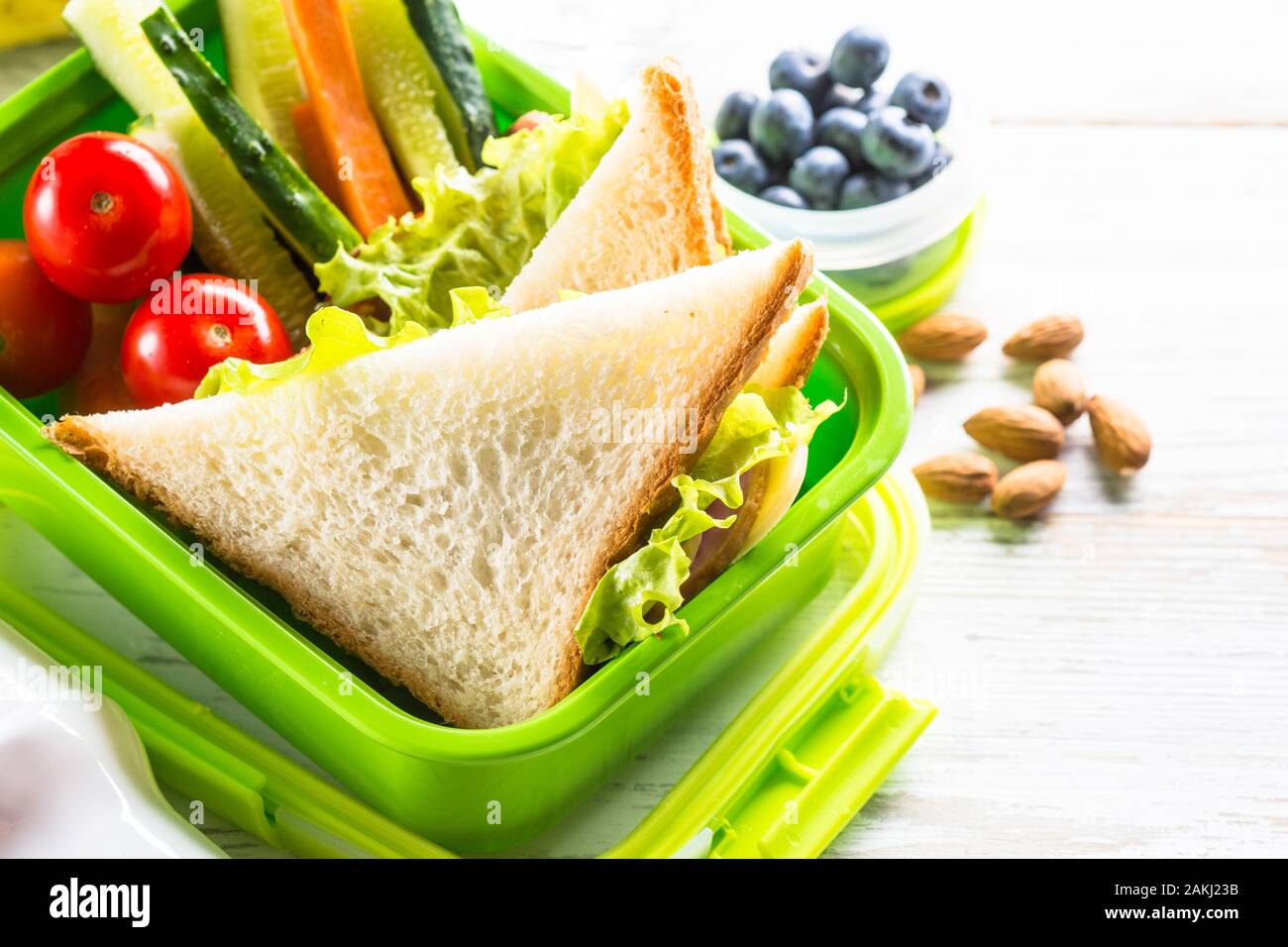 Lunch box with sandwich, vegetables, berries and nuts Stock Photo - Alamy