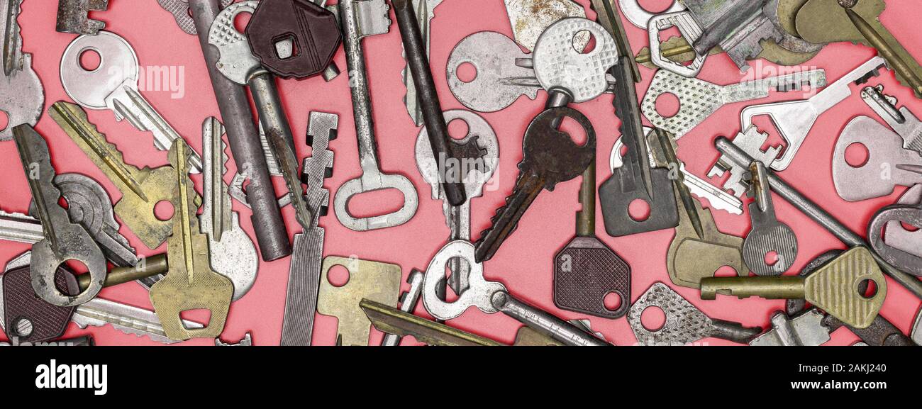 Keys set on pink background. Door lock keys and safes for property ...