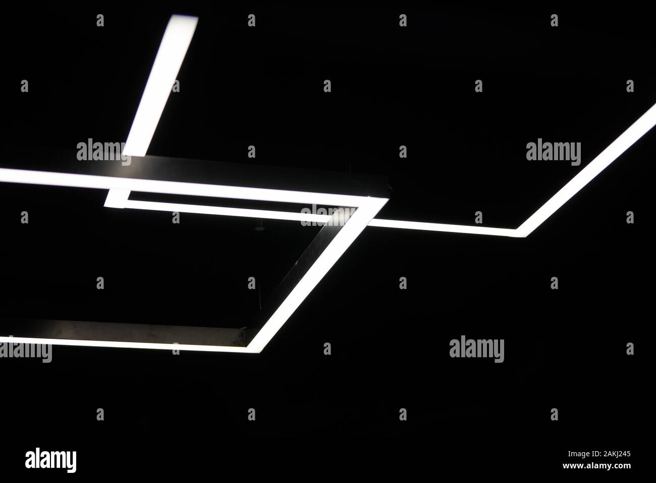 Modern office lighting. Thin lamps in office dark ceiling. LED white ...