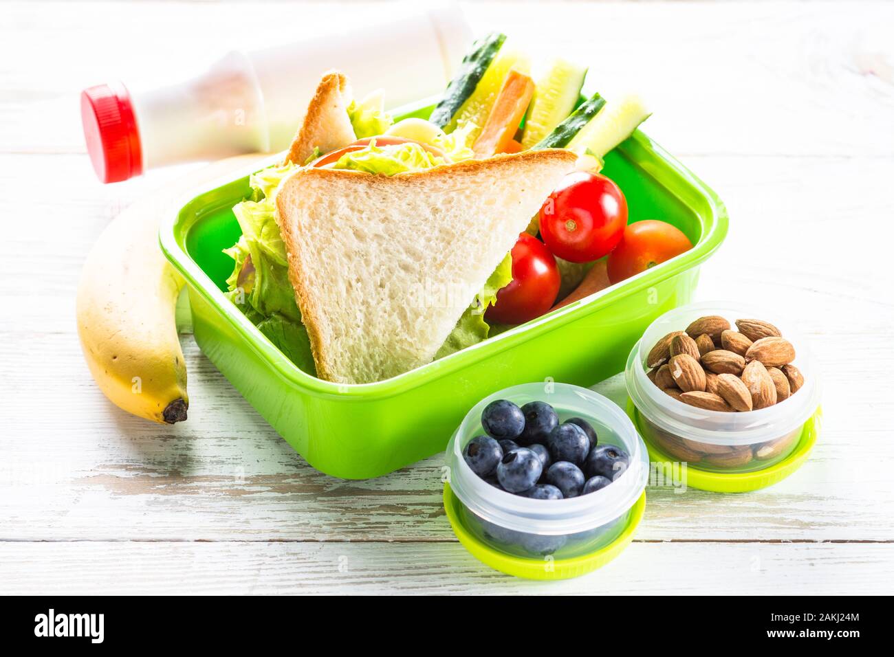 Lunch box with sandwich, vegetables, berries and nuts Stock Photo - Alamy