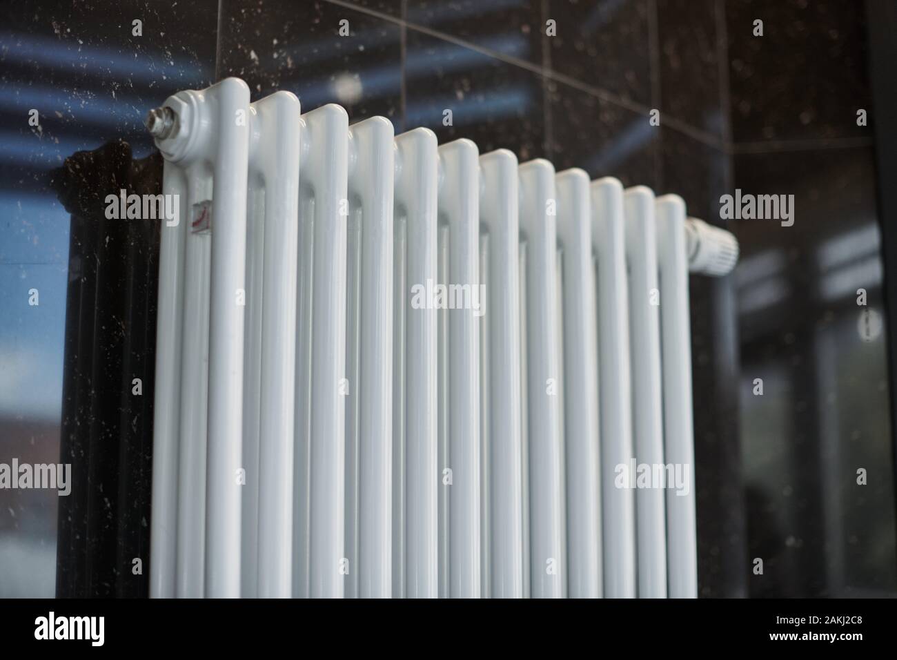 Heating radiator in office, close up. White heat exchangers. Iron ...