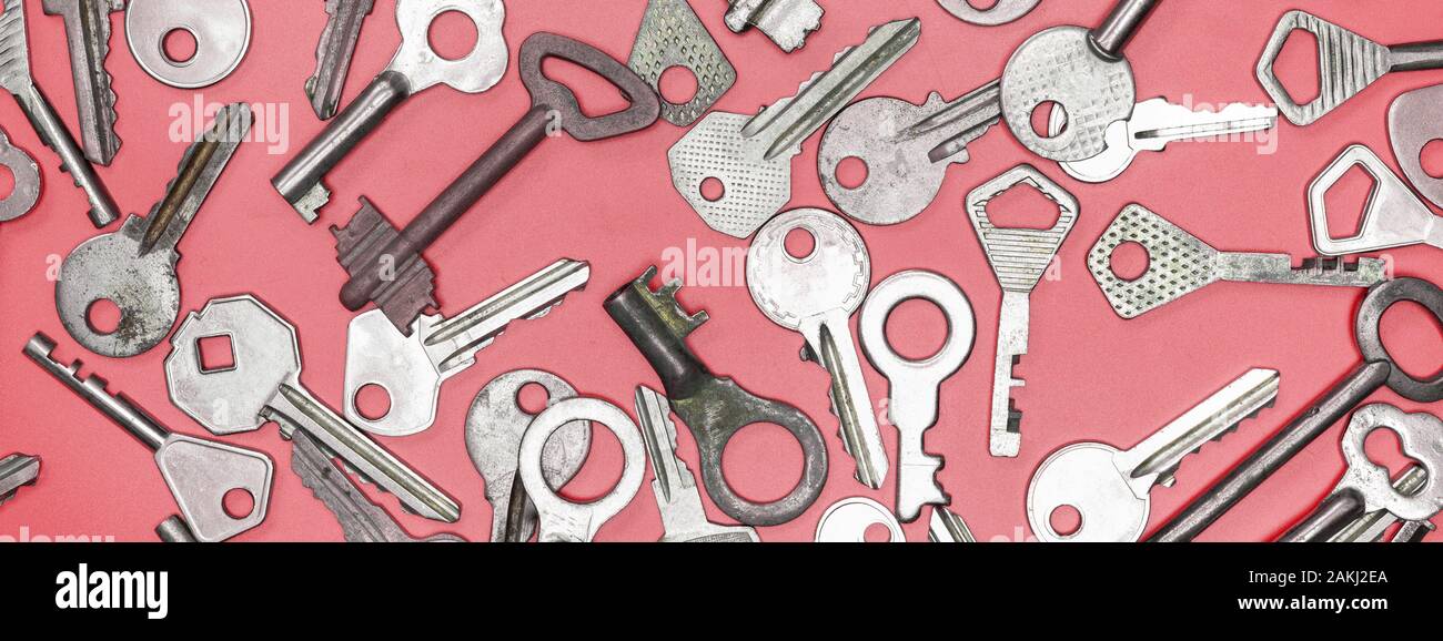 Keys set on pink background. Door lock keys and safes for property ...