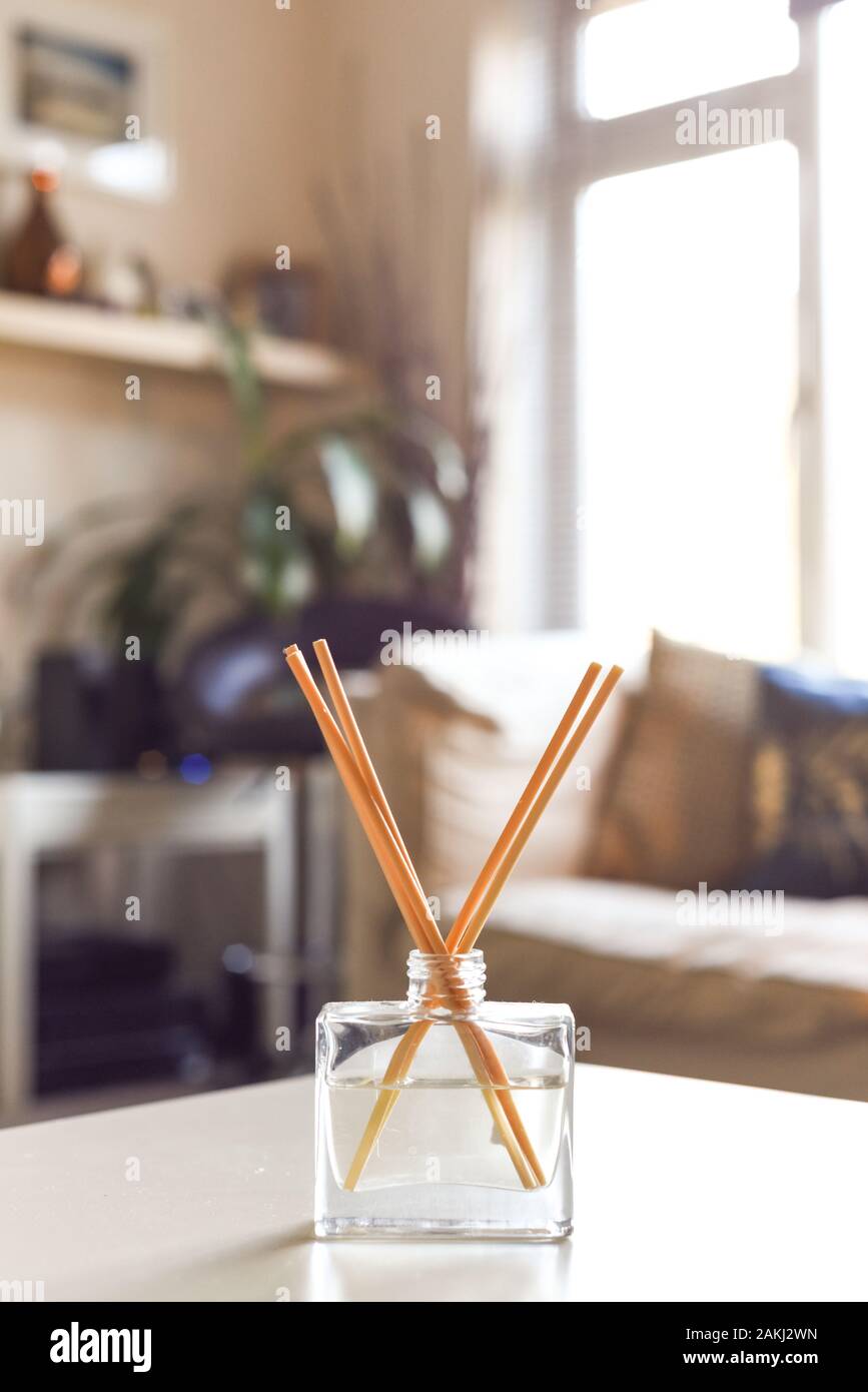 Reed diffuser to fragrance home interior on the coffee table of a light ...