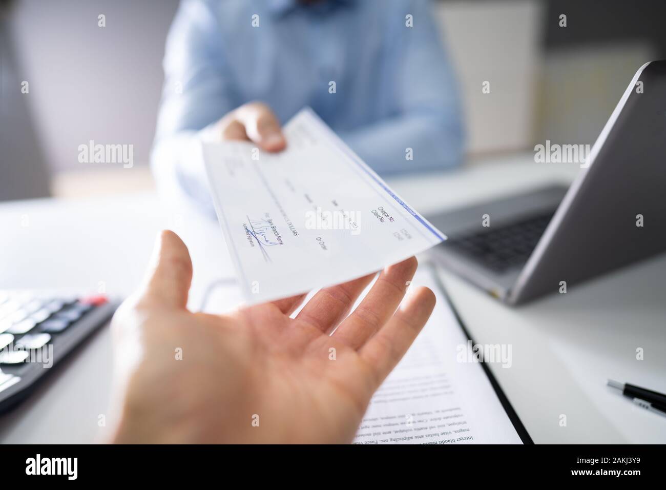 Businessperson Hands Giving Cheque To Other Person Stock Photo - Alamy