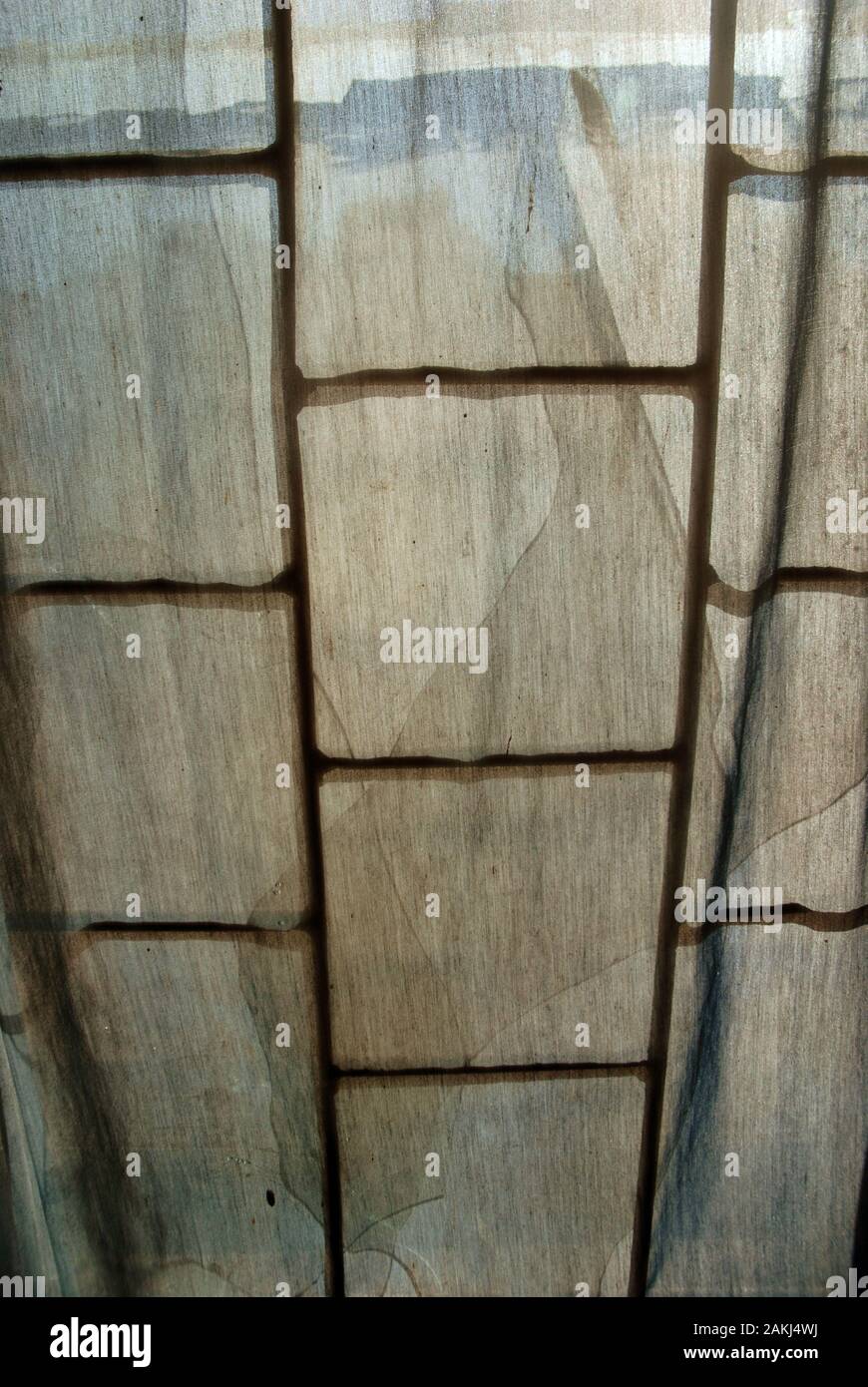 Old net curtains at a shuttered window in abandoned post office, Mwandi ...