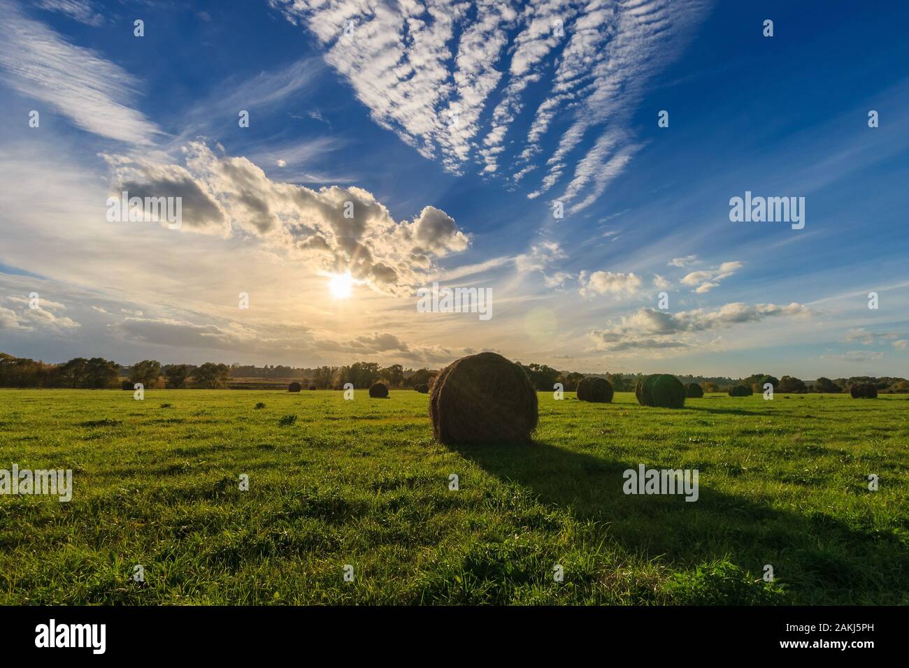 field with haystacks at sunset in early autumn evening Stock Photo - Alamy