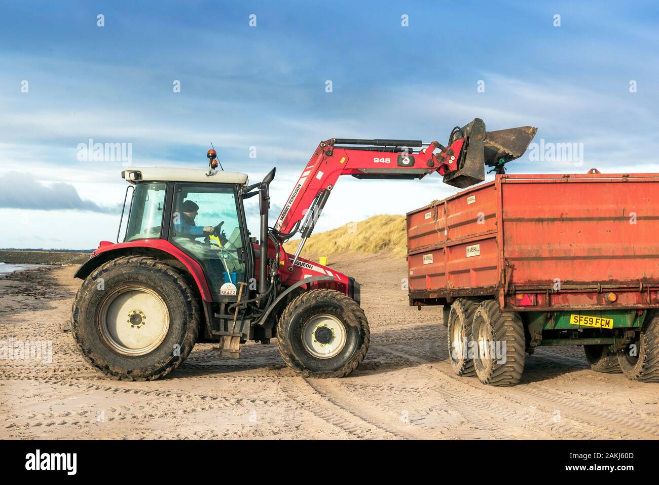 Tractor and trailer being used to clean the pollution and rubbish from ...