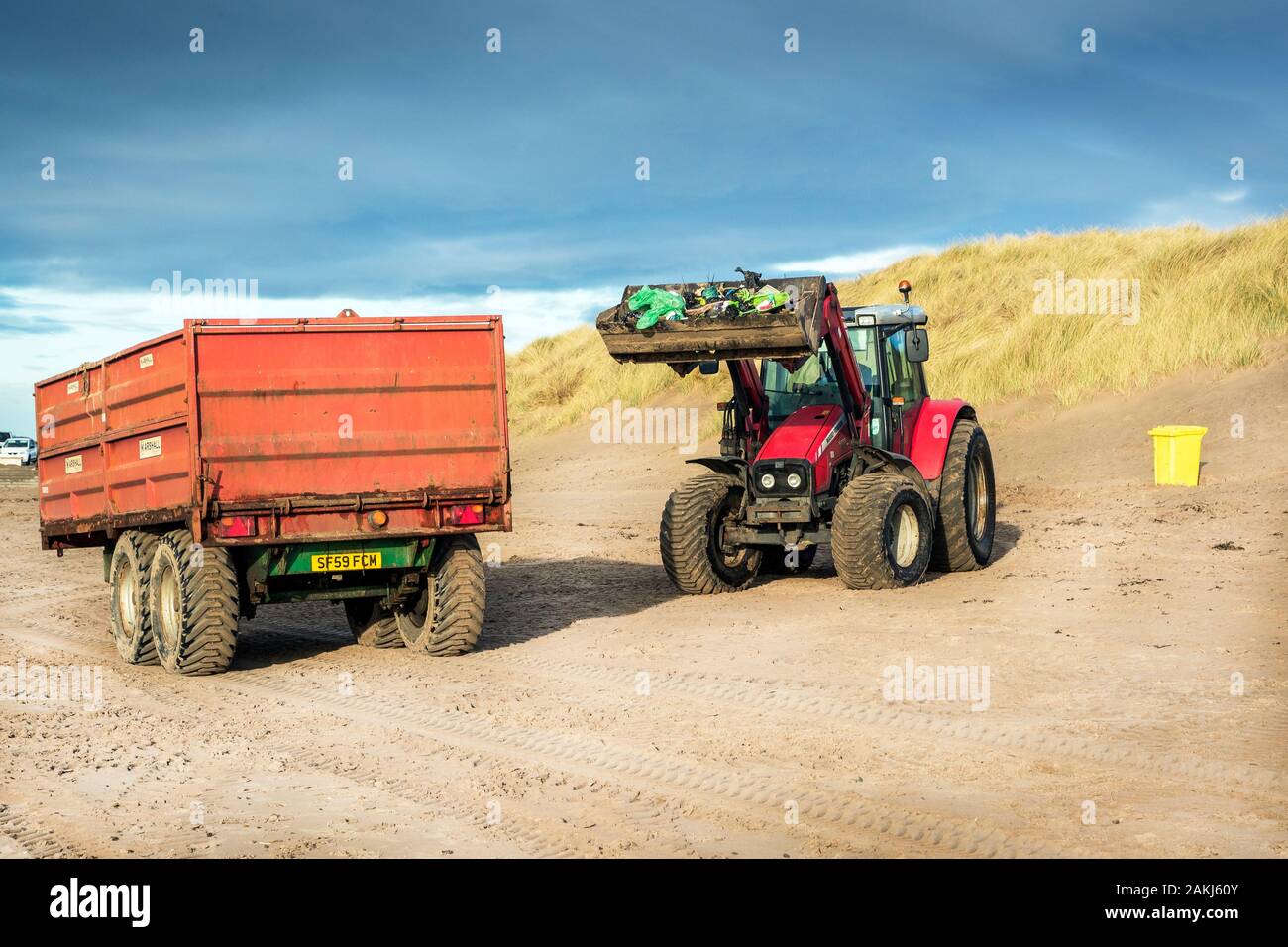 Tractor and trailer being used to clean the pollution and rubbish from ...